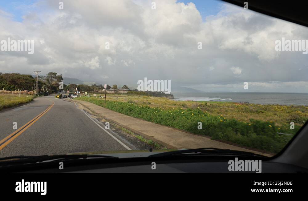 Driving by Point Dume state park where big surf breaks on a rainy day ...