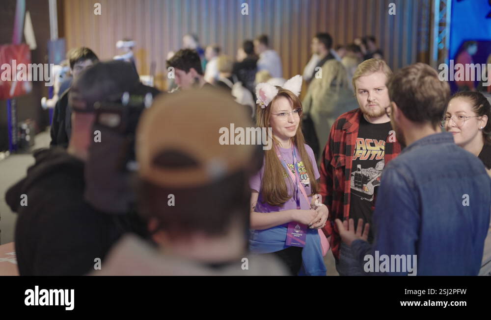 Group of people on gaming event interviewed by TV reporter team 4K ...