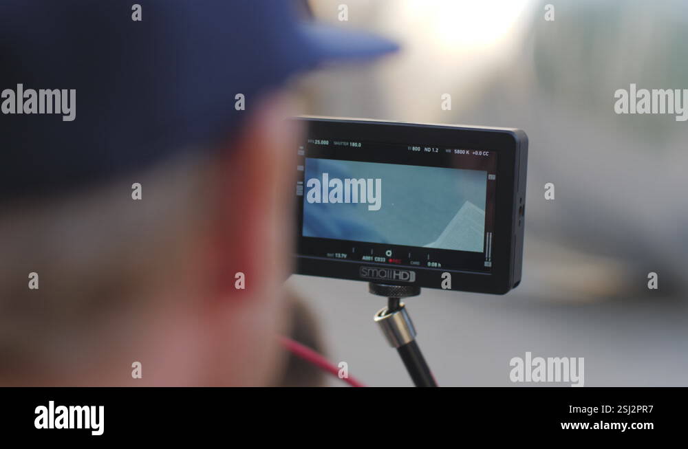 Cameraman controls process of filming on camera monitor Stock Video ...