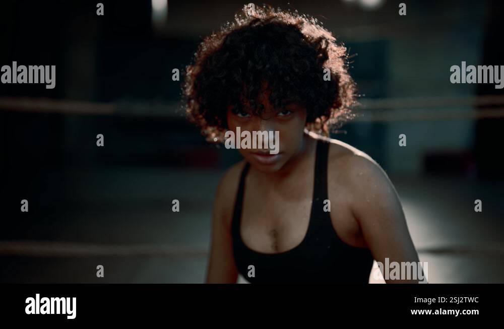 Strong fighter american curly girl boxer clapping with boxing gloves on ...
