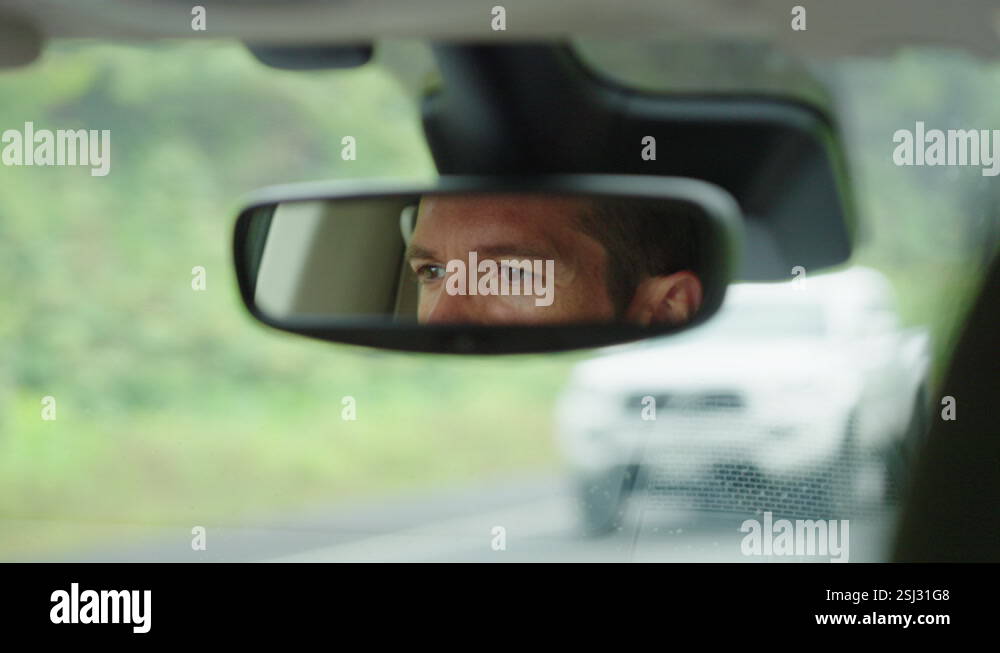 Man Eyes Reflection In Car Review Mirror While He Concentrates On ...