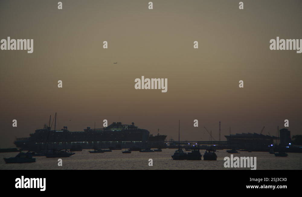 Zoom out from a plane to a cruise port with boats at a bay in Panama ...