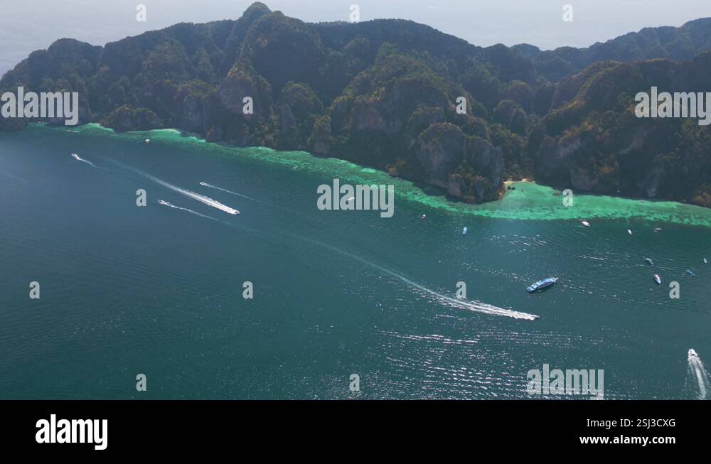 Slow cinematic drone tilt up over Limestone cliffs at Phi Phi Islands ...