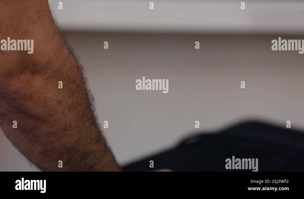 A man wears a mask and checking a microphone with the sound system ...