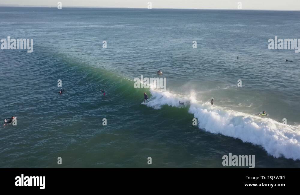Young man surfer surfing ocean wave on surfboard slow motion sunset ...