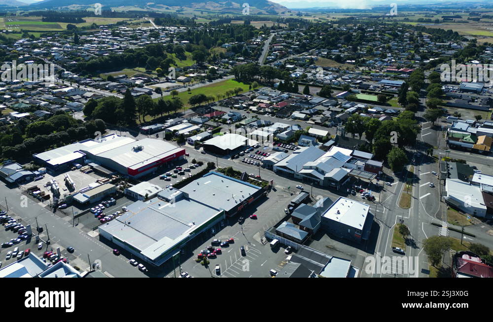 Shopping mall in center of Gore town in New Zealand, aerial orbit view ...