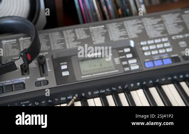 Sony headphones on Casio piano next to the sound system. The camera ...