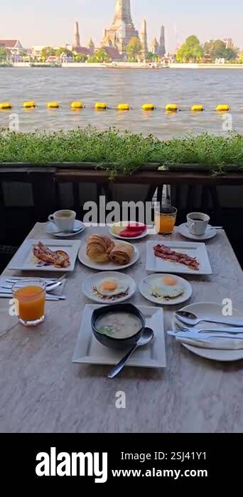 A lavish breakfast spread awaits by the river in Bangkok, featuring ...
