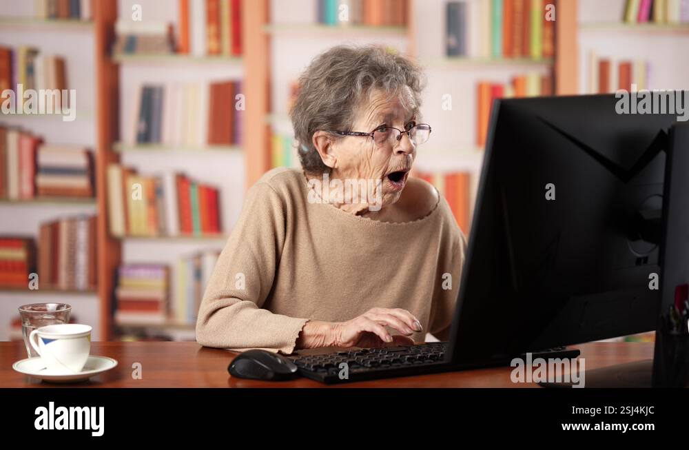 Senior elderly old woman reading computer screen notice letter from ...