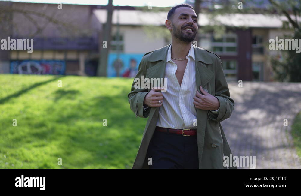 One Middle Eastern man celebrating success outside at park jumping with ...