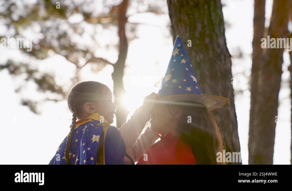 Child plays with his mother in costumes of wizard. Child plays in ...