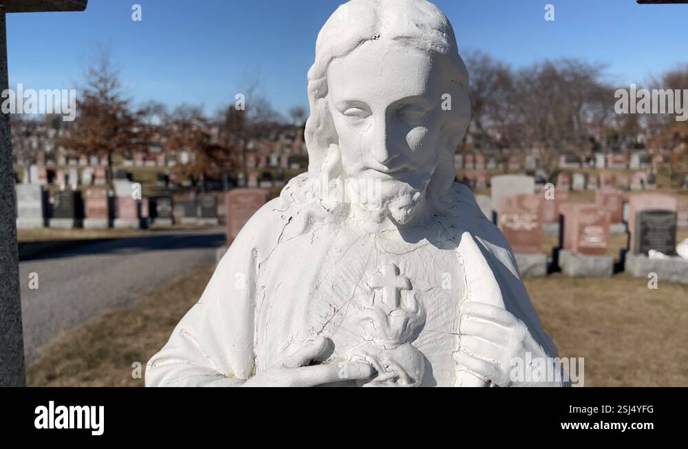 Jesus Christ Satue in a Christian Cemetery With Headstones Around Stock ...