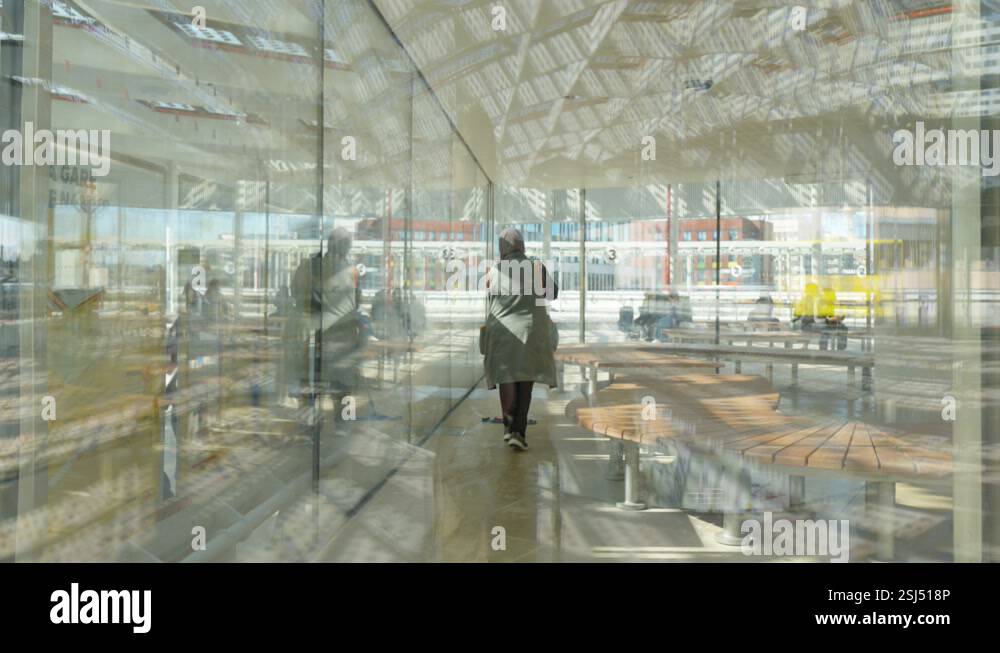 Arab female worker with hijab cleaning the floor of the bus station ...