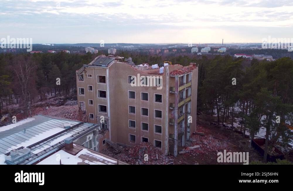 Partially demolished apartment building surrounded by rubble. Dolly ...