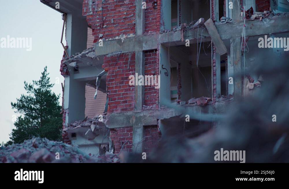 Partially demolished apartment building surrounded by rubble Stock ...