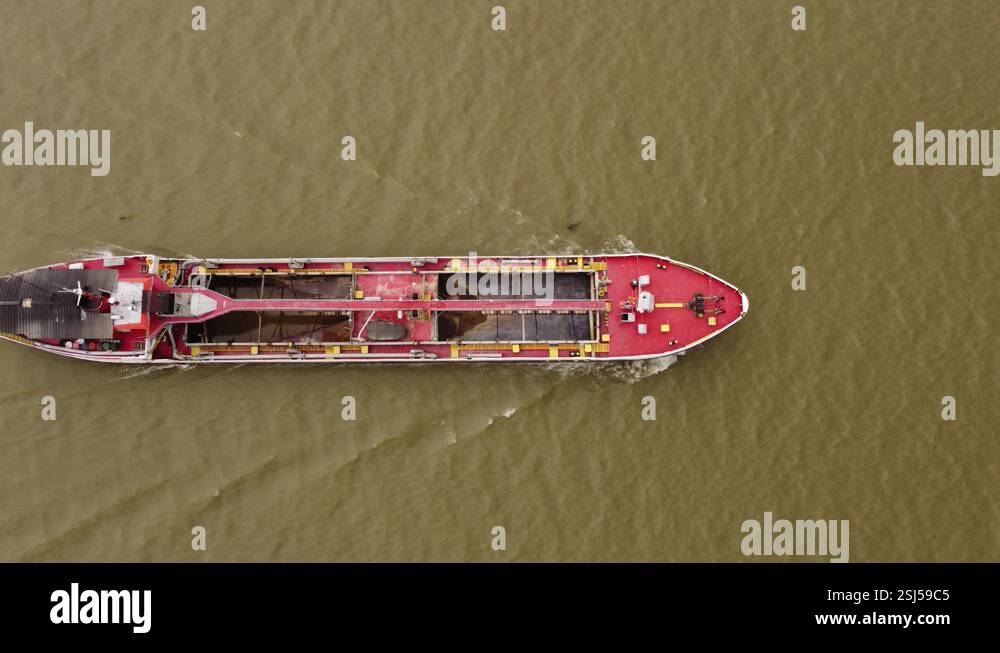 Aerial landing overhead flight over industrial Large cargo ship sailing ...