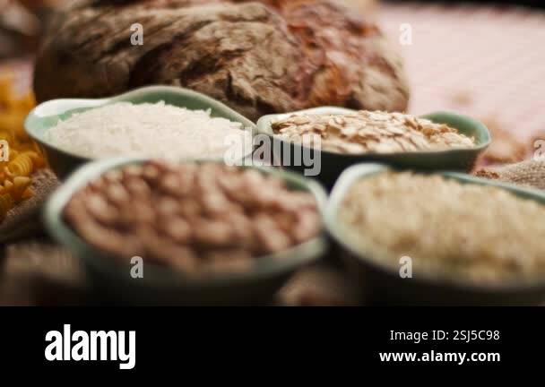 Close-up of assorted carbohydrate-rich foods arranged on a table ...