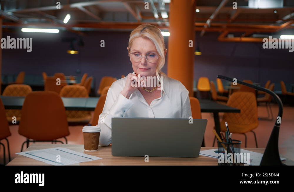 Lady boss working on project in modern loft style empty office on ...