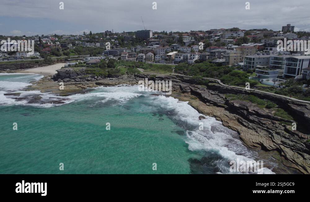 Foamy Splashing On The Rocky Shoreline Of Tamarama Point In New South ...