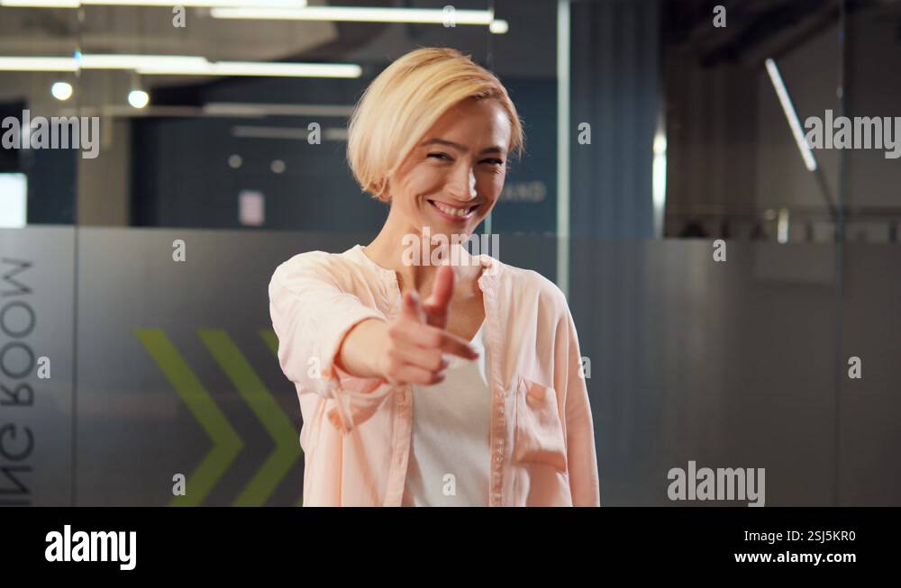 Girl pointing finger at camera and saying Hey, come over here, while ...