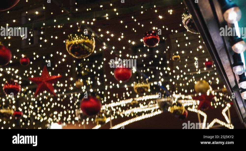 Anamorphic shot of a glowing warm string of light and red, golden and ...