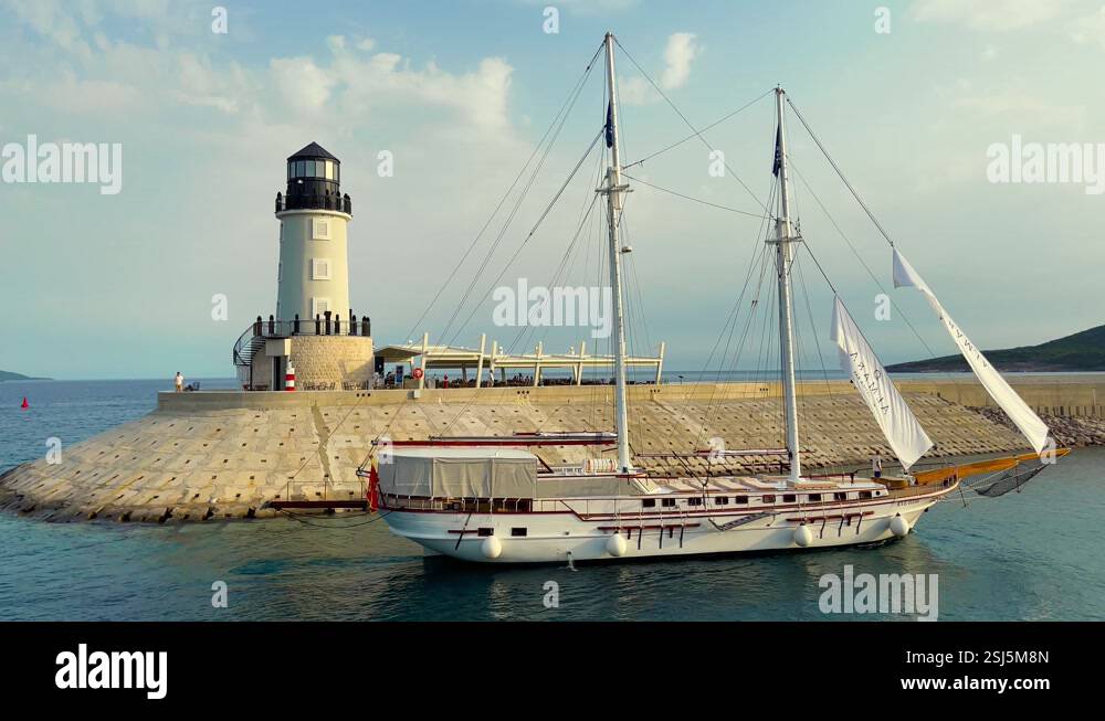 Lighthouse by the sea against mountain in Lustica Bay, Montenegro Stock ...