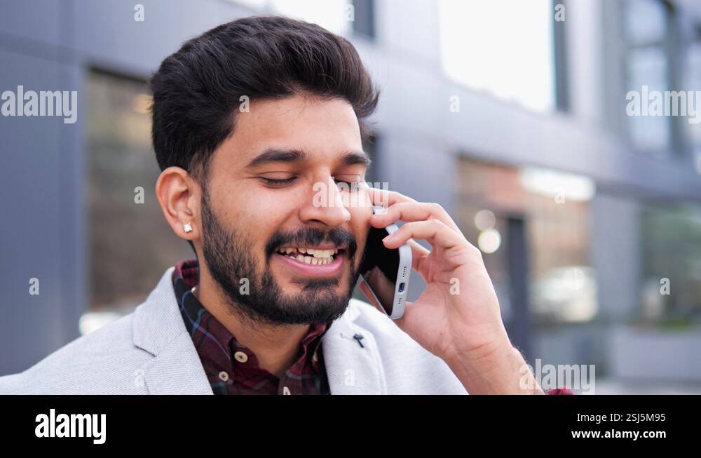 Closeup portrait of handsome Indian man having phone conversation ...