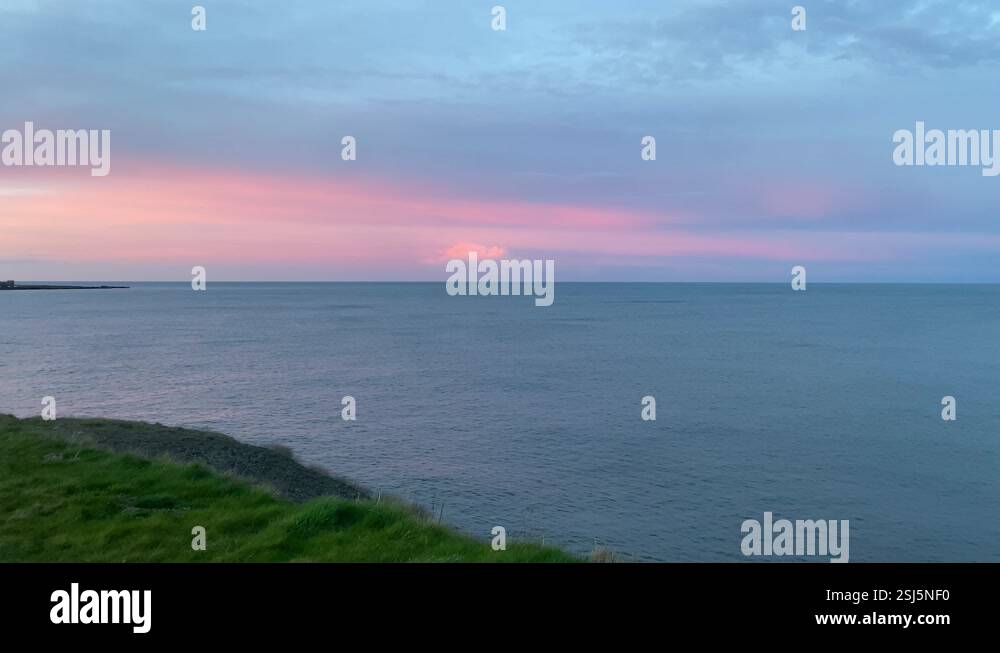A sunset over the North Sea in England, UK - Sunderland. Panning shot ...