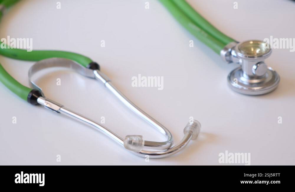Stethoscope on the table in the clinic. Green stethoscope. Health care ...