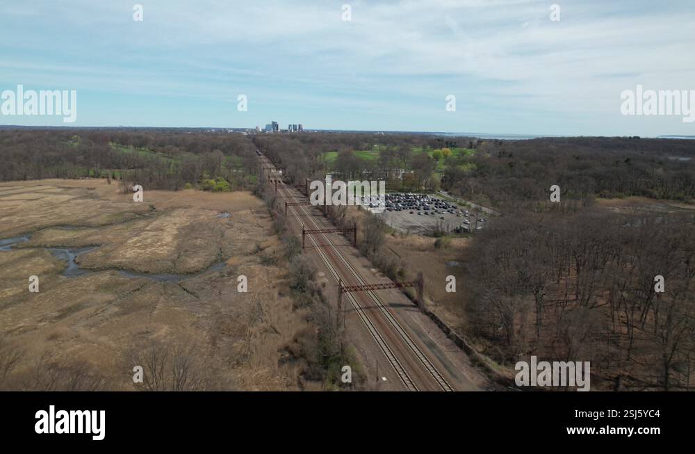 An aerial view of a train traveling off far in the distance in The ...