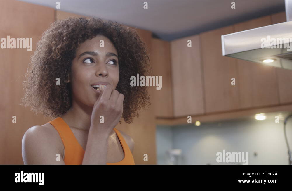 Pretty and fit woman can be seen happily enjoying a healthy and ...