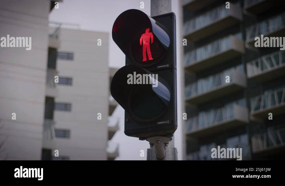 Slow zoom-in on traffic light that finally turns green. On a busy ...