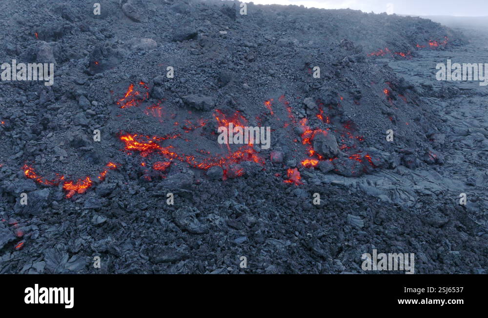 Natural aerial shot on drone of red hot lava flowing and freezing with ...