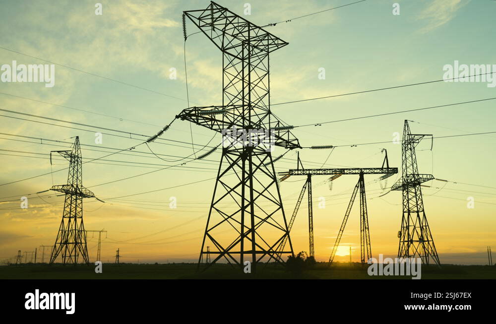 High voltage electrical towers at sunset. Energy, power lines ...