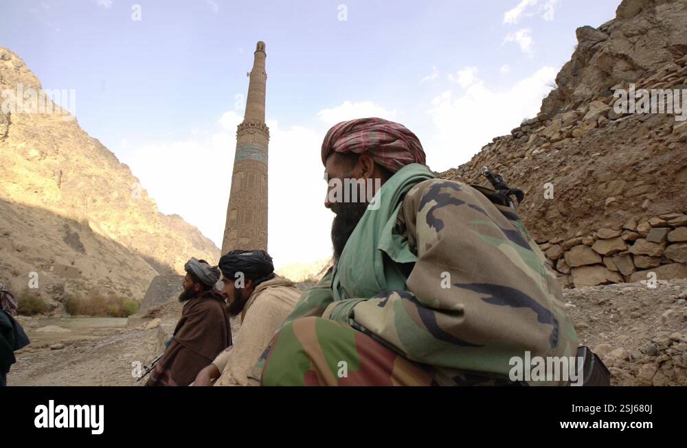 Afghan Taliban men in traditional clothes by Minaret of Jam, side view ...