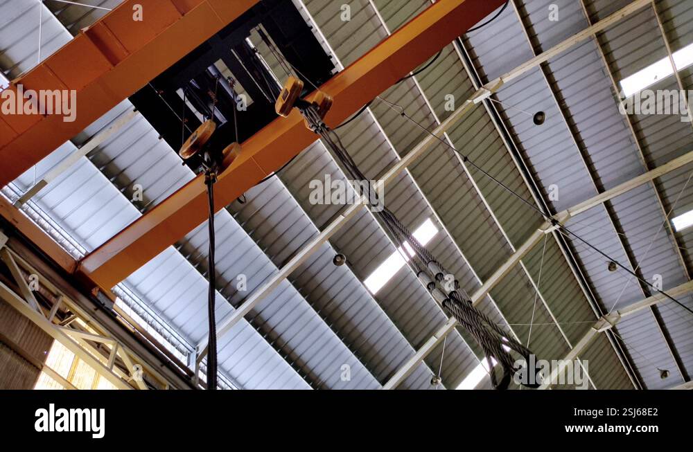 Yellow overhead crane in a factory. Large crane at a factory. Shot from ...