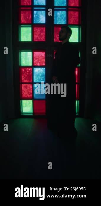 Vertical full-length portrait of young catholic priest dressed in black ...