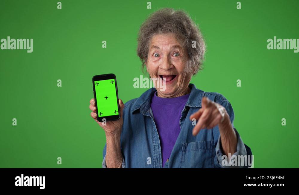Funny crazy elderly old toothless woman posing with phone with green ...