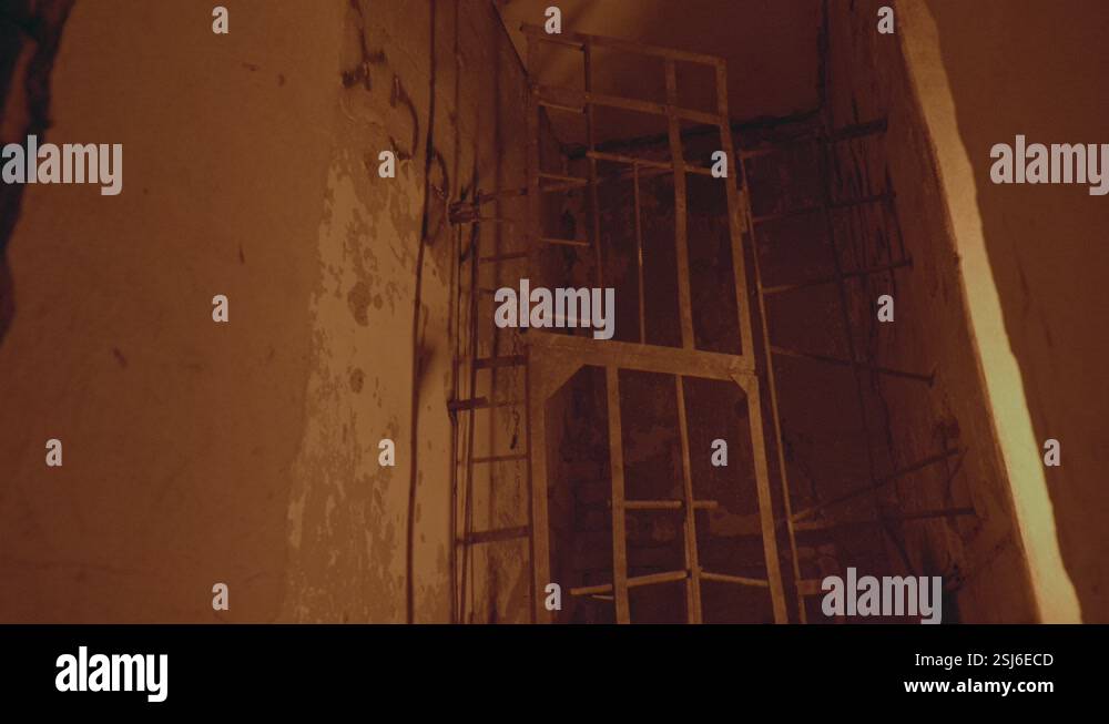 an abandoned building. the gate door or grate opens and closes by ...