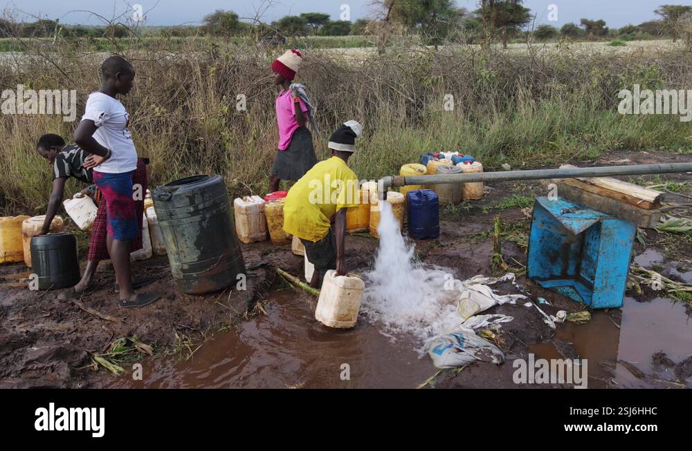 Masai people gather clean water by well in Kenya. Water shortage in ...