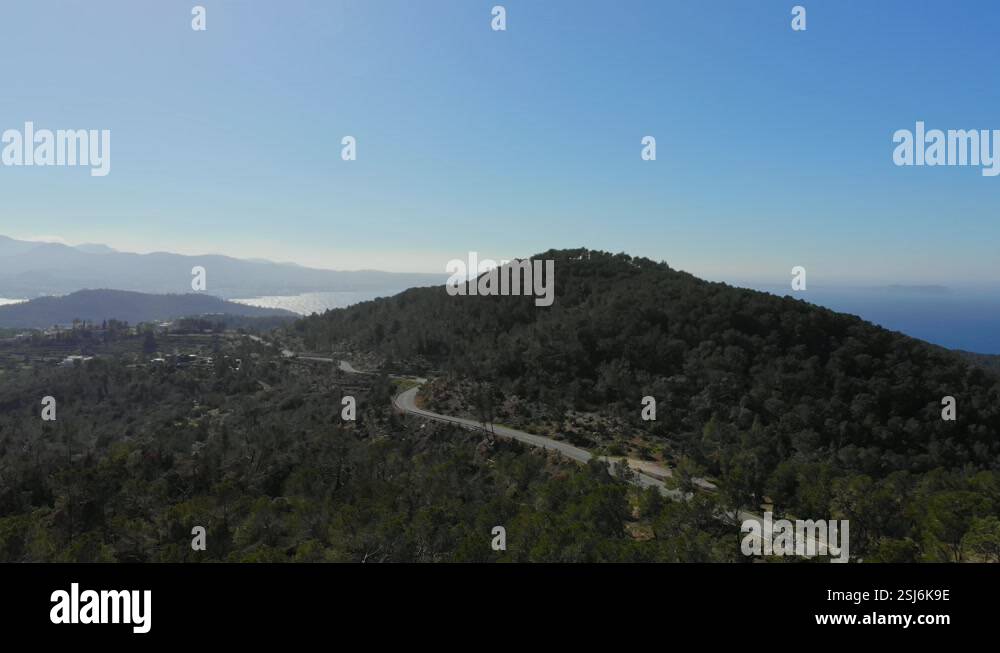 Ibiza forward over road and hill with water in the background Stock ...