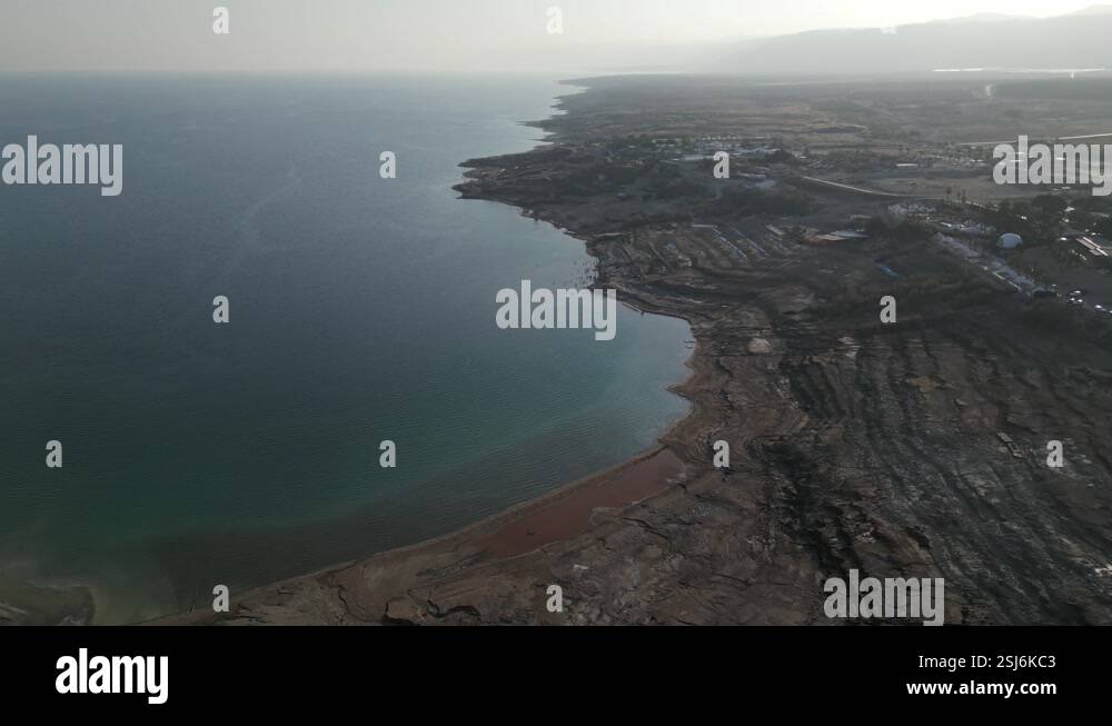 Aerial view of the texturized expanding shoreline in the Dead Sea as ...