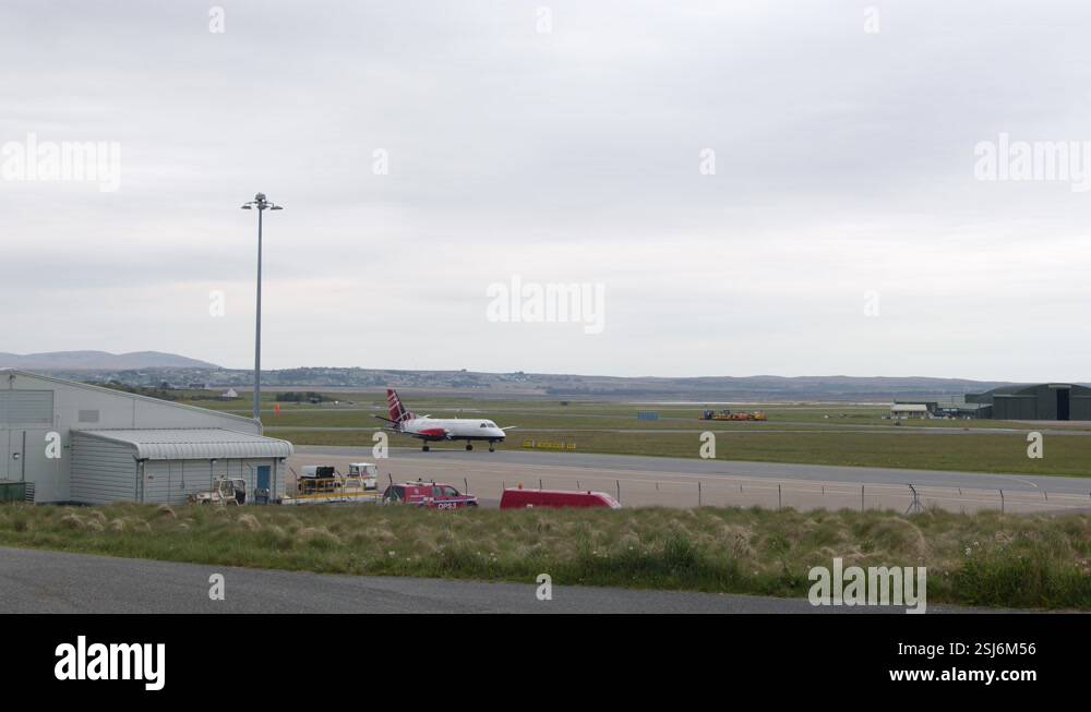 Shot of a small passenger plane taxiing outside an airport terminal in ...