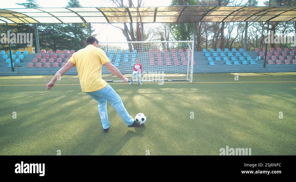 Father and Son play football on stadium, Happy family outdoors, bonding ...