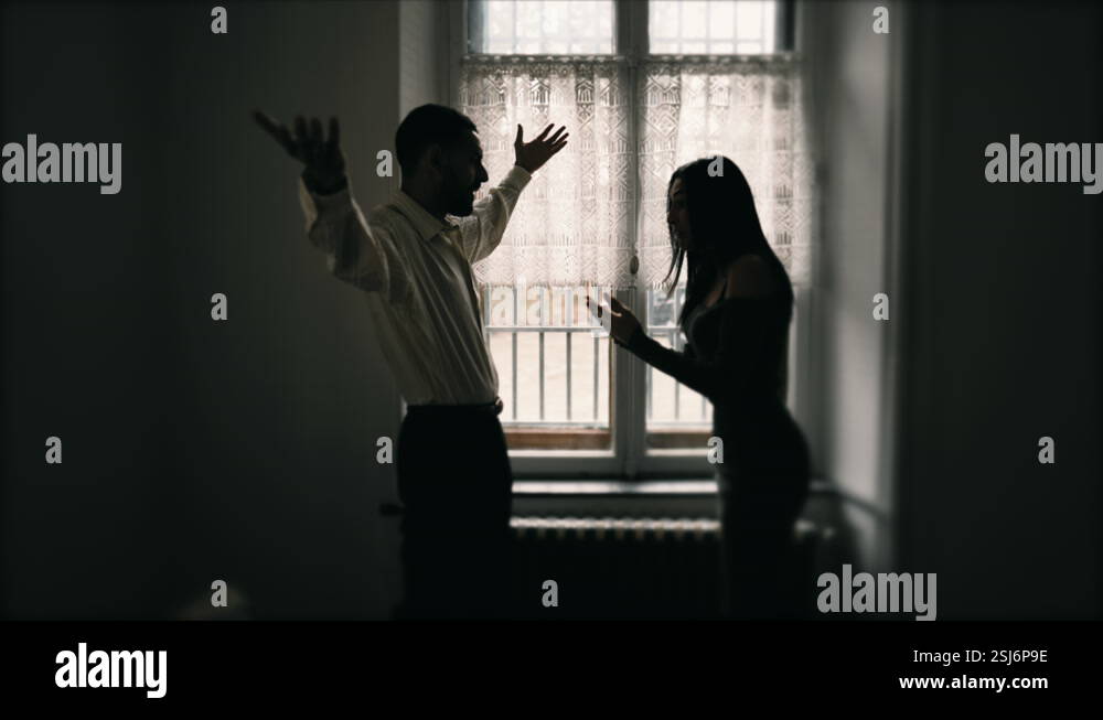 Silhouette of couple fighting each other, arguing and yelling at one ...