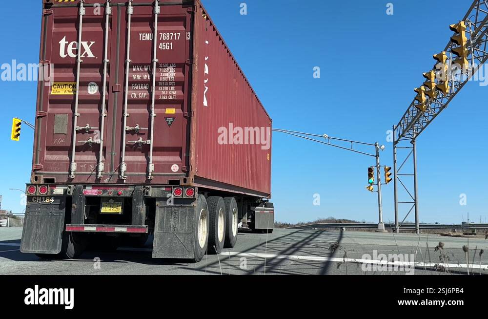 Truck with a semi-trailer makes traffic at an intersection with traffic ...
