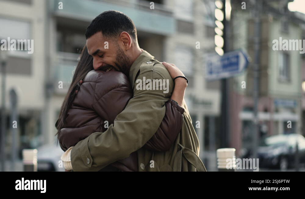 Two best friends embrace in city street. Joyful couple happy reunion in ...