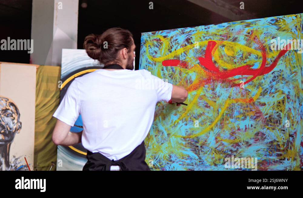 Charismatic talented beautiful artist uses his brush to create a ...
