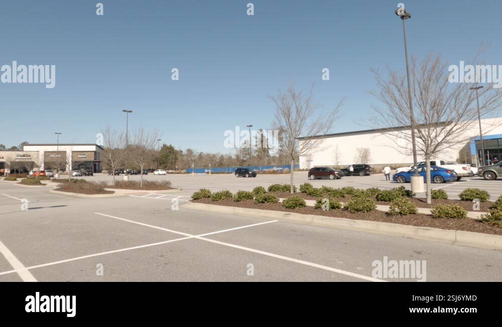 Retail strip mall exterior parking lot and people on Washington road ...
