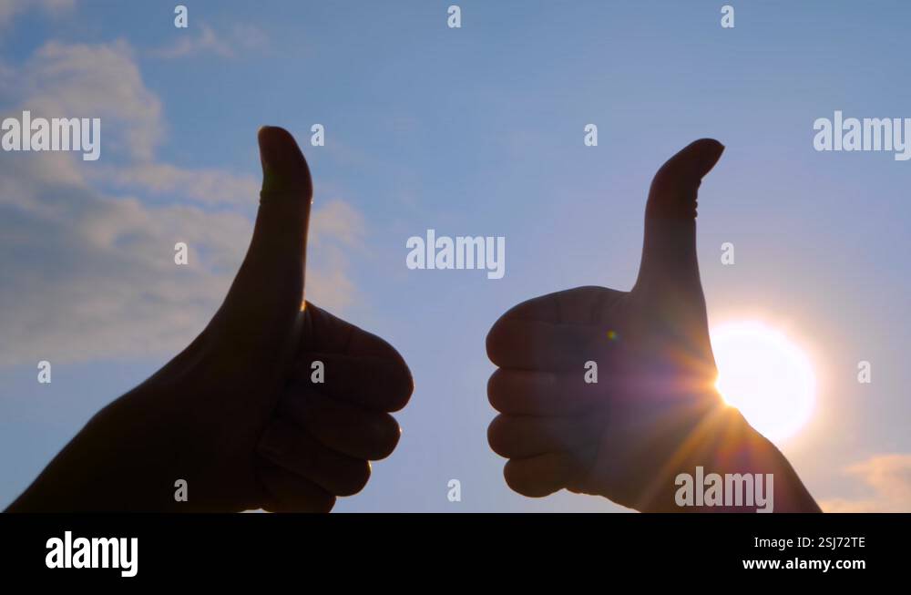 Silhouette of woman is showing two hands with thumbs up gesture - sun ...